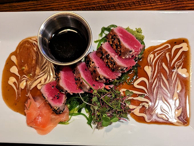 The seared ahi tuna arrives like edible art&mdash;ruby-red slices fanned across the plate with sauces creating a Jackson Pollock-worthy backdrop that's almost too beautiful to eat. Almost.