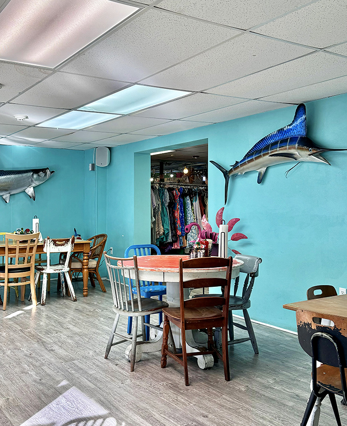 The storefront proudly announces its multiple personalities&mdash;bakery, cafe, vintage shop&mdash;with colorful chairs standing guard like a rainbow welcoming committee.