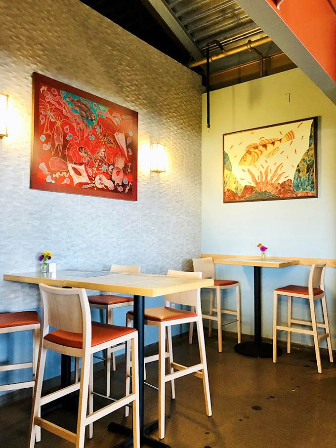 Colorful artwork and clean lines create a dining space that feels both sophisticated and welcoming&mdash;like the coastal home of your most culinarily talented friend.