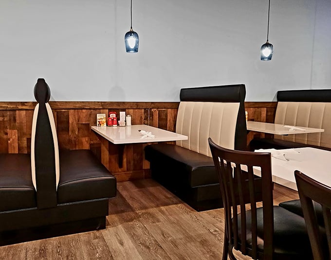 Cozy booths with rustic wood paneling create intimate dining spaces. The perfect setting for solving the world's problems over coffee and pie.