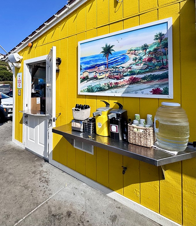 That sunshine-yellow exterior isn't just cheerful&mdash;it's practically therapeutic. The coastal painting reminds you exactly why you came.
