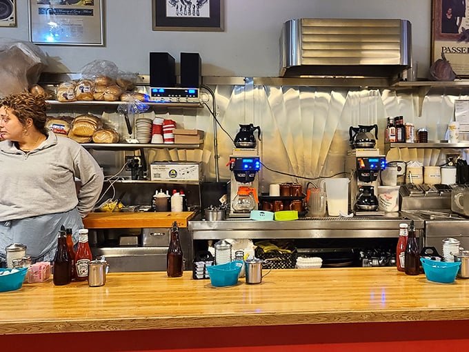 Behind the counter, where breakfast magic happens with military precision and decades of experience.