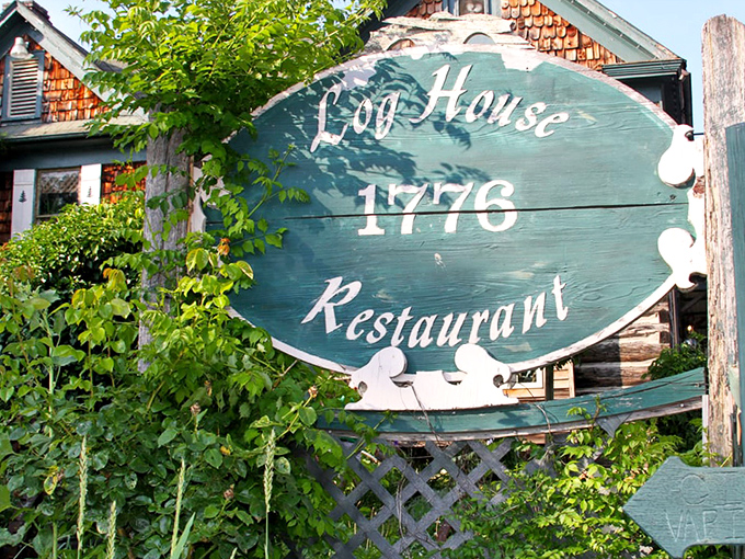 The sign that's guided hungry travelers for generations. Like a green beacon of culinary promise saying, "Yes, the food is as authentic as our weathered logs."