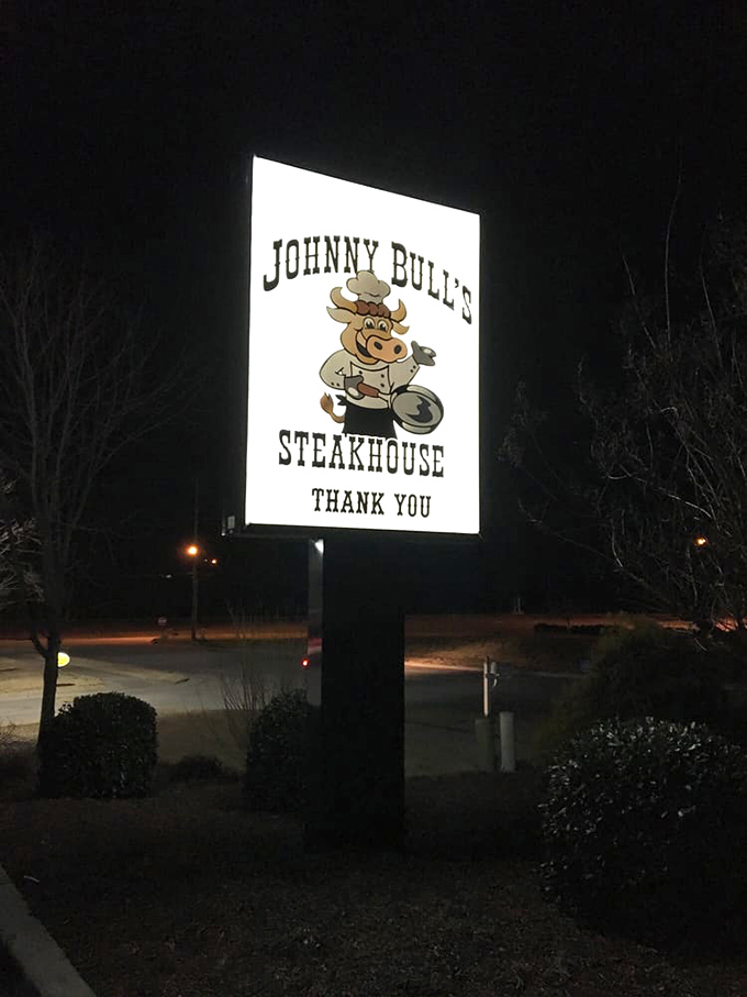 The illuminated sign shines like a beacon in the night, guiding hungry travelers to their beefy salvation.