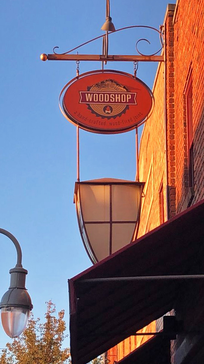 The hanging sign catches golden hour light, beckoning hungry travelers like a barbecue lighthouse guiding ships to delicious shores.