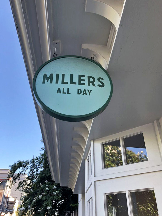 The mint-green sign hangs like a beacon of breakfast hope, promising all-day access to morning delights when pancake cravings strike at 3pm.