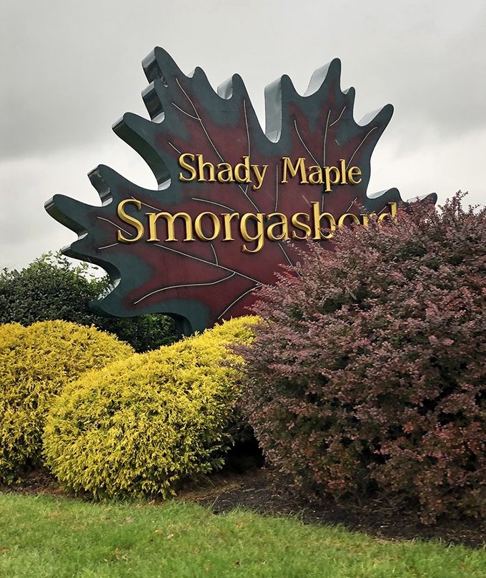 The maple leaf sign stands as both invitation and warning: enter here and you'll leave with memories, satisfaction, and possibly a new pants size.