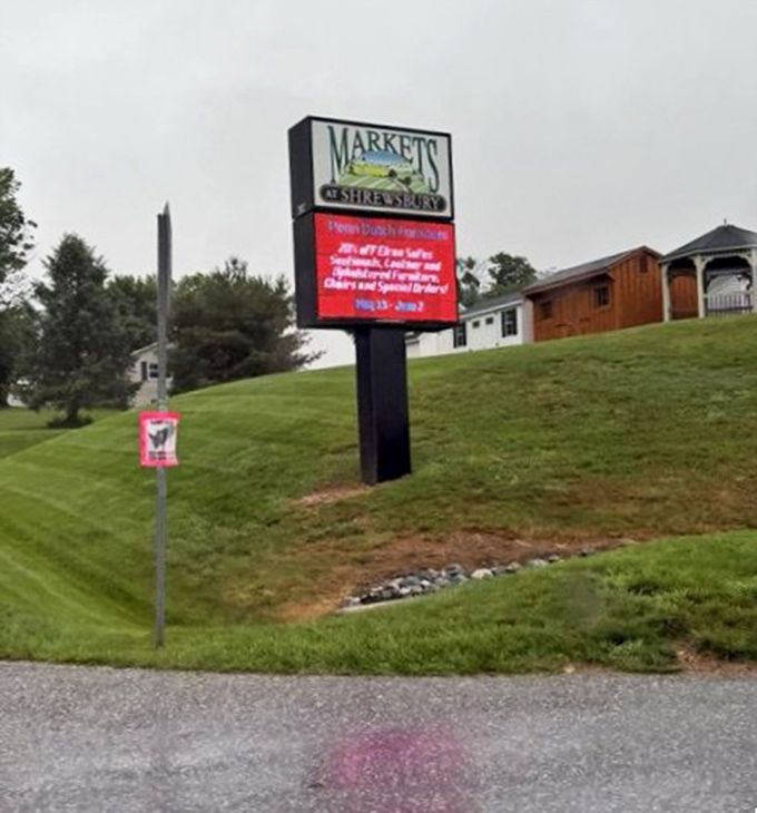 The roadside sign stands like a promise: extraordinary experiences ahead. For food pilgrims, it's as meaningful as any highway landmark in America.