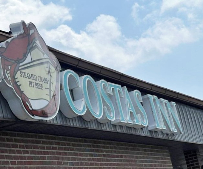 The iconic Costas Inn sign featuring a crab that seems to say, "Yes, this is the place you've been hearing about. Come on in."