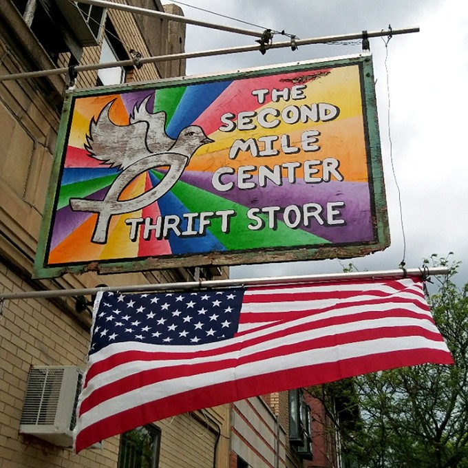 The vibrant rainbow sign with its dove symbol promises more than just bargains&mdash;it's a beacon of second chances for items and shoppers alike.