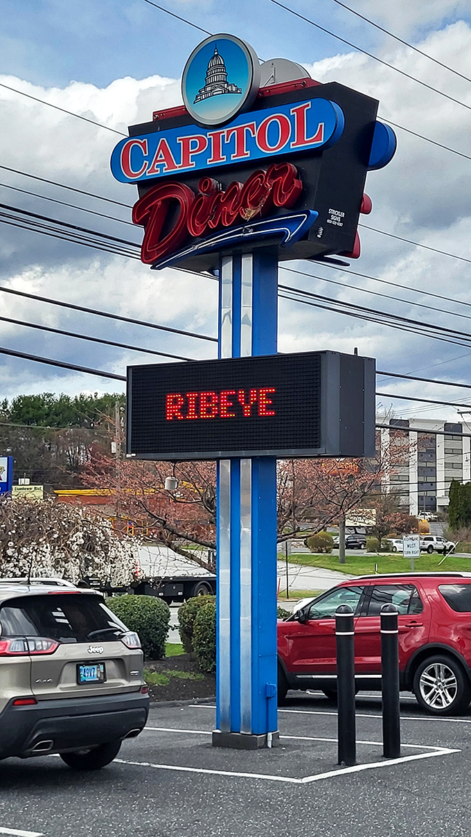 The roadside sign announces "RIBEYE" with the urgency of breaking news - because in diner world, a good steak special is breaking news.