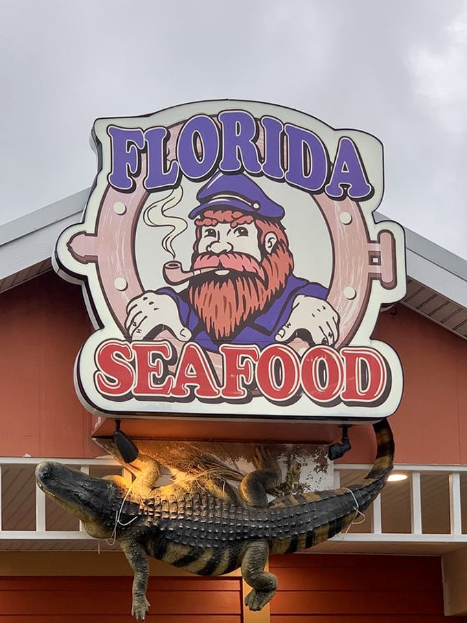 The restaurant's mascot keeps watch with his pipe, seemingly saying, "Yes, there's an alligator hanging below me. This is Florida, what did you expect?"