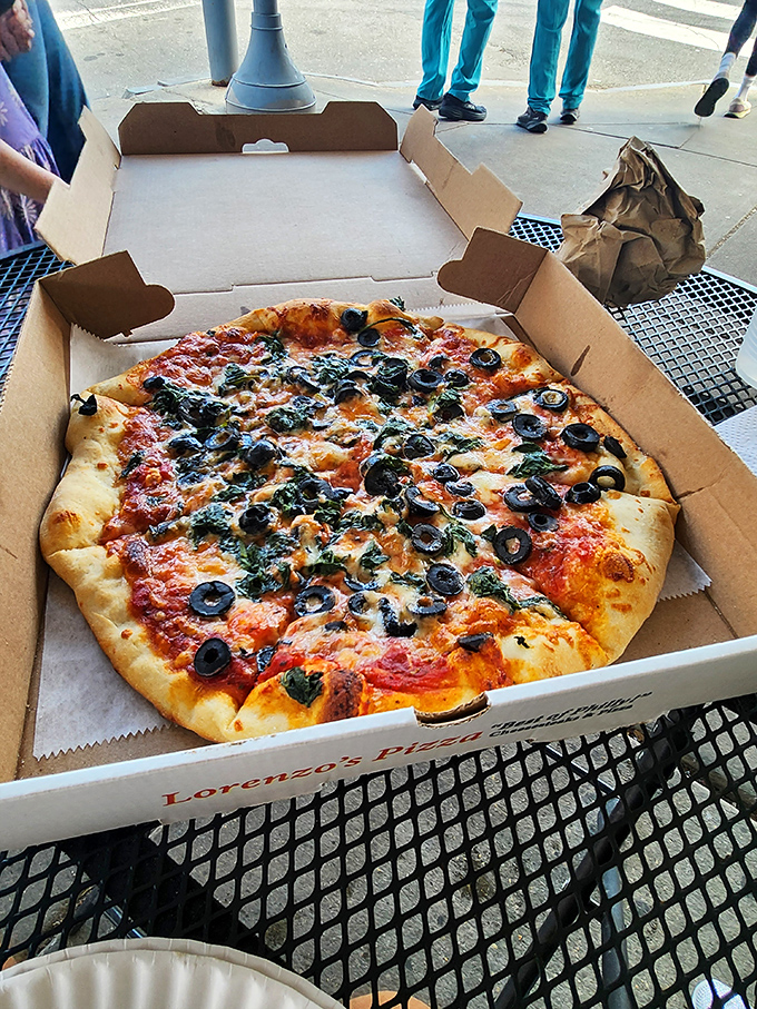 Black olives and spinach pizza—for when you want to pretend you're eating healthy while still indulging in cheesy perfection.