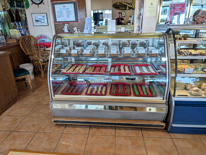 The display case offers a panorama of pastry perfection. Like the Louvre of baked goods, each piece deserving its own velvet rope.