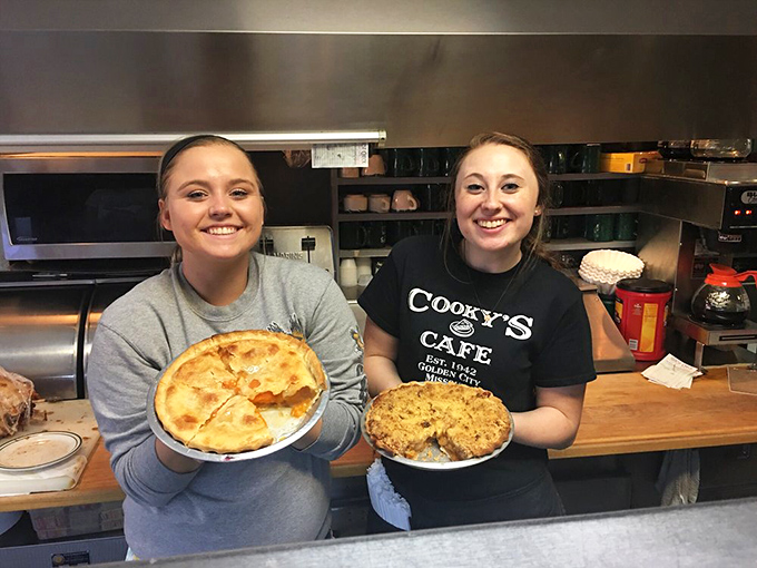The proud pie artisans of Cooky's showing off their handiwork—these aren't just desserts, they're edible works of art.