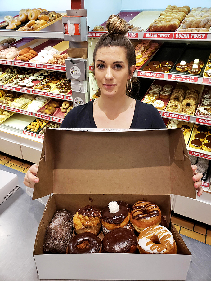 Behind every great donut is a dedicated team. The display case behind them tells the real story.