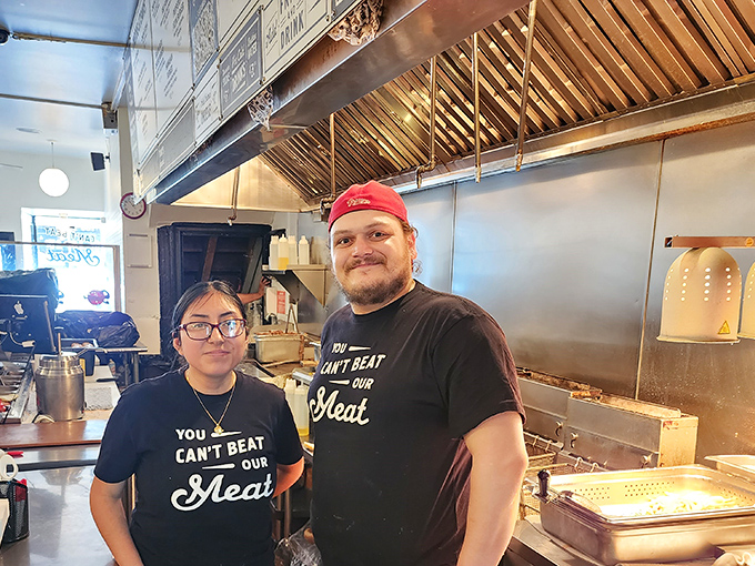 The team behind the magic, sporting shirts that boldly state what locals already know: their meat truly is unbeatable.