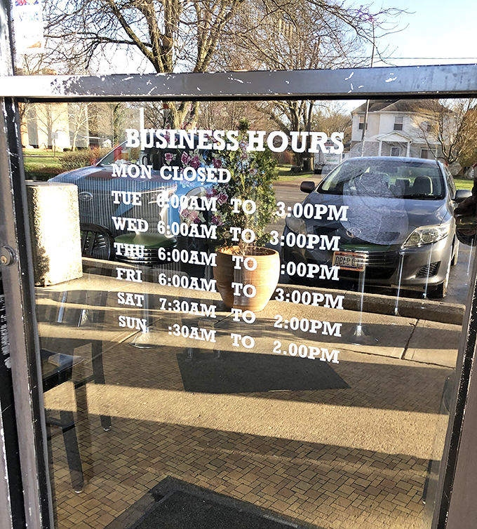 The business hours sign&mdash;a roadmap to happiness that wisely includes being closed on Mondays, because even breakfast legends need a day off.