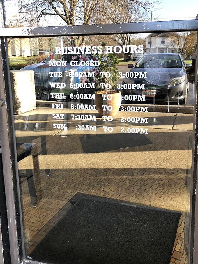 Clear hours posted on glass doors promise consistent comfort food availability for early birds and weekend brunchers alike.