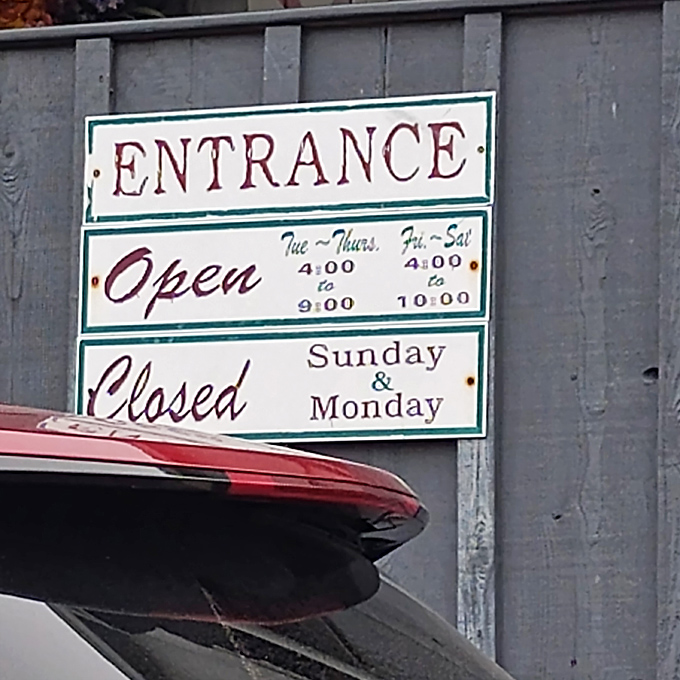 The hours sign reveals the rhythm of rural dining&mdash;closed Sundays and Mondays, because even legendary chicken fryers need a weekend.