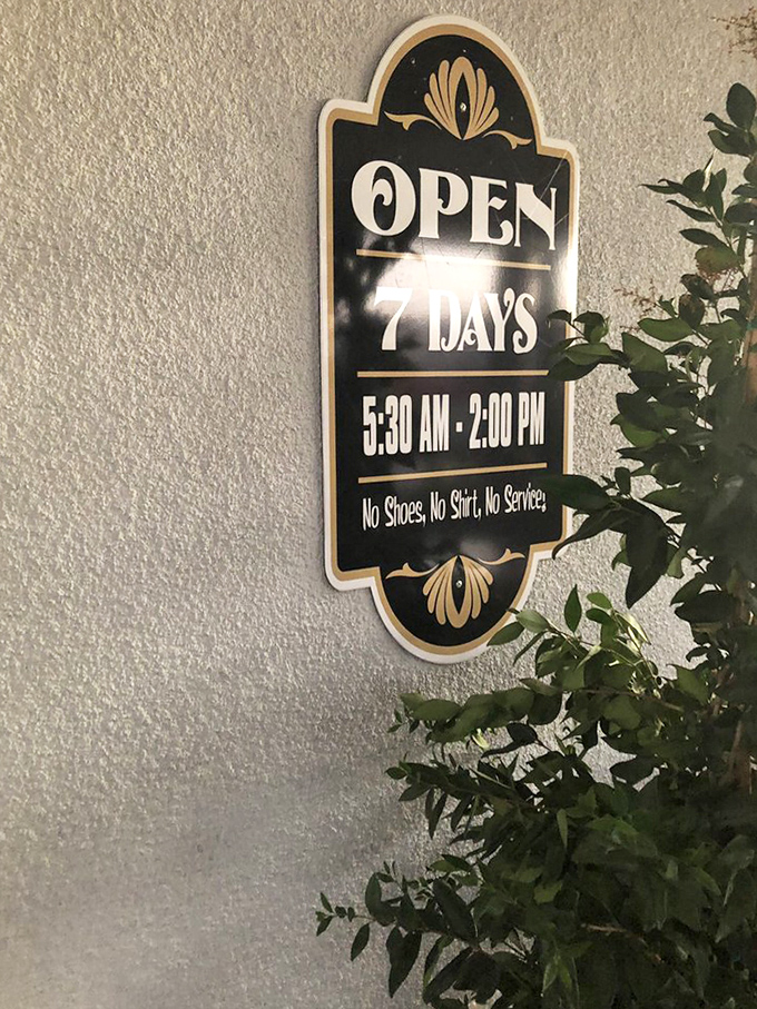 The hours sign tells you everything about Sandy's philosophy: open early for the farmers, closed after lunch, and absolutely no service for the shoeless or shirtless crowd.