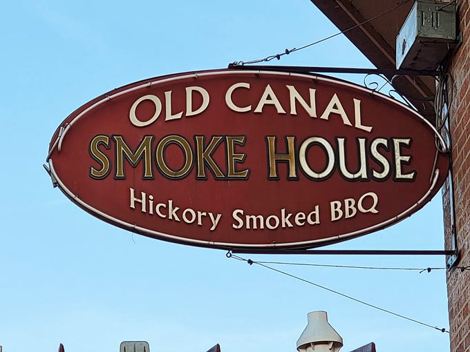 The vintage-style sign announces its hickory-smoked mission against the blue Ohio sky, a landmark for barbecue pilgrims seeking smoky salvation.