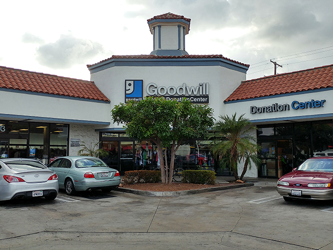 The Goodwill mothership beckons with its distinctive blue and white logo—a beacon of sustainable shopping in a sea of retail sameness.