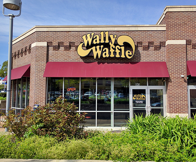 The storefront stands proudly among landscaping, like a breakfast superhero ready to rescue you from your morning hunger.