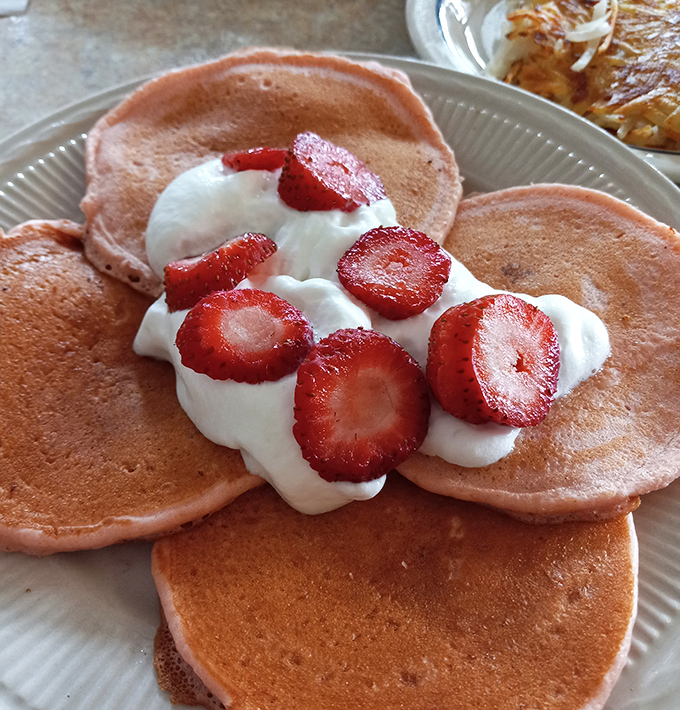 Strawberry pancakes that make you question why anyone would ever choose cereal. That whipped cream isn't just a topping&mdash;it's a necessity.