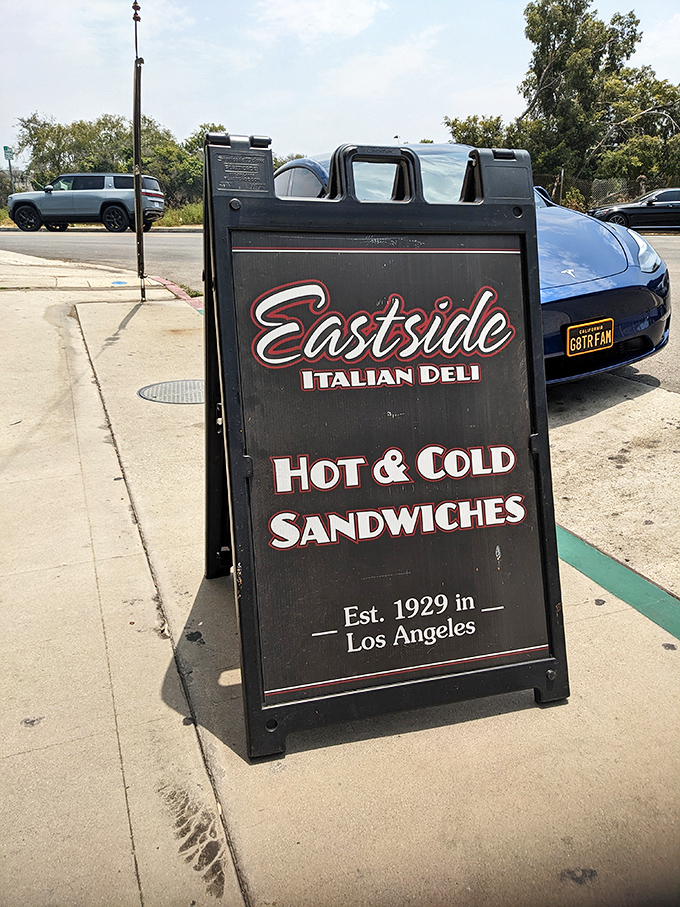 The sidewalk sign stands like a sentry, guiding hungry pilgrims to sandwich salvation since 1929 &ndash; some traditions are worth preserving.
