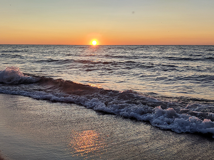 As the sun makes its grand finale, Lake Michigan transforms into liquid gold, proving that the best light shows don't require tickets.
