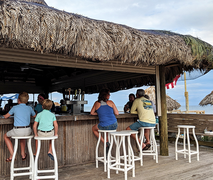 The tiki bar &ndash; where island drinks are poured with a heavy hand and conversations flow as easily as the Gulf breeze.