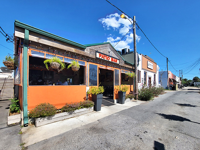 Visit the vibrant Raw Bar with its cheerful orange facade, where seafood arrives so fresh it practically introduces itself before hitting your plate.