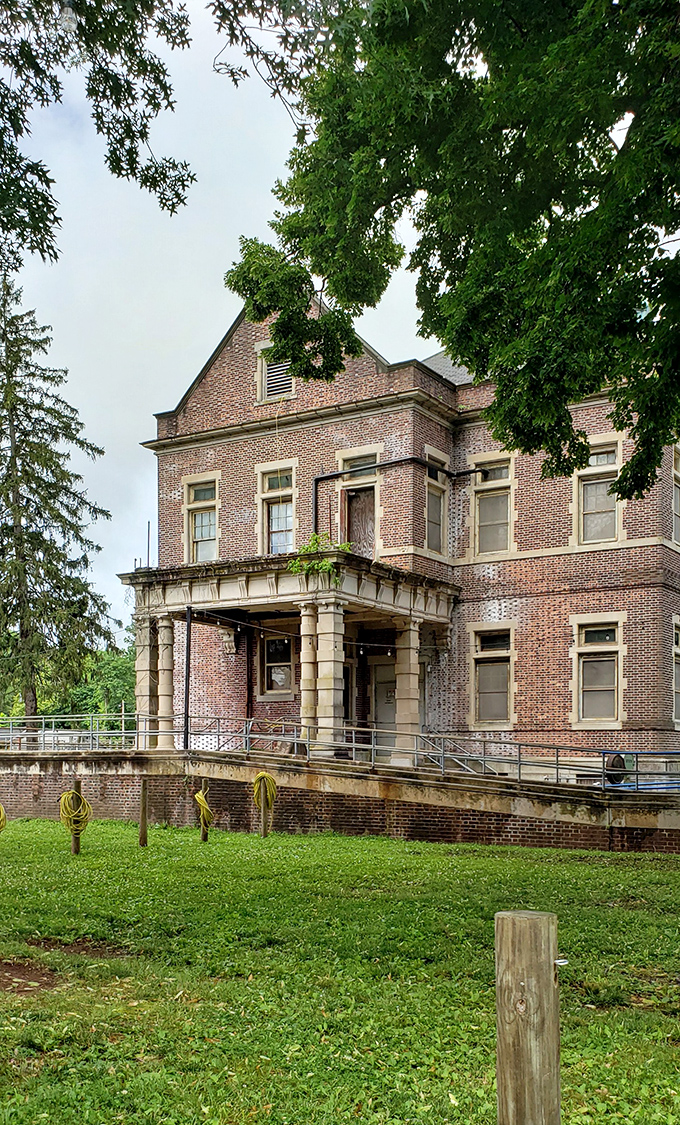 The stately entrance portico, with its classical columns, presents a dignified face that belies the complex history contained within these walls.
