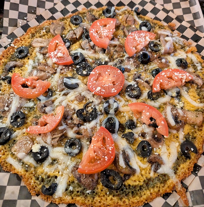 Pizza perfection with a twist &ndash; fresh tomatoes and black olives atop a golden cheese canvas that makes traditional crust seem unnecessary.