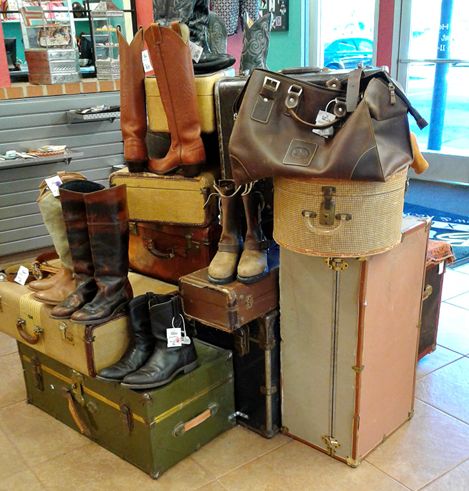 A luggage tower becomes art installation, topped with boots and bags that whisper tales of adventures past and future.