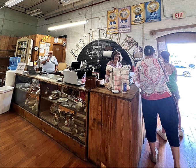 The checkout counter&mdash;where treasure hunters part with cash and gain conversation pieces. That smile says, "Yes, I really do need this 1940s butter churn."