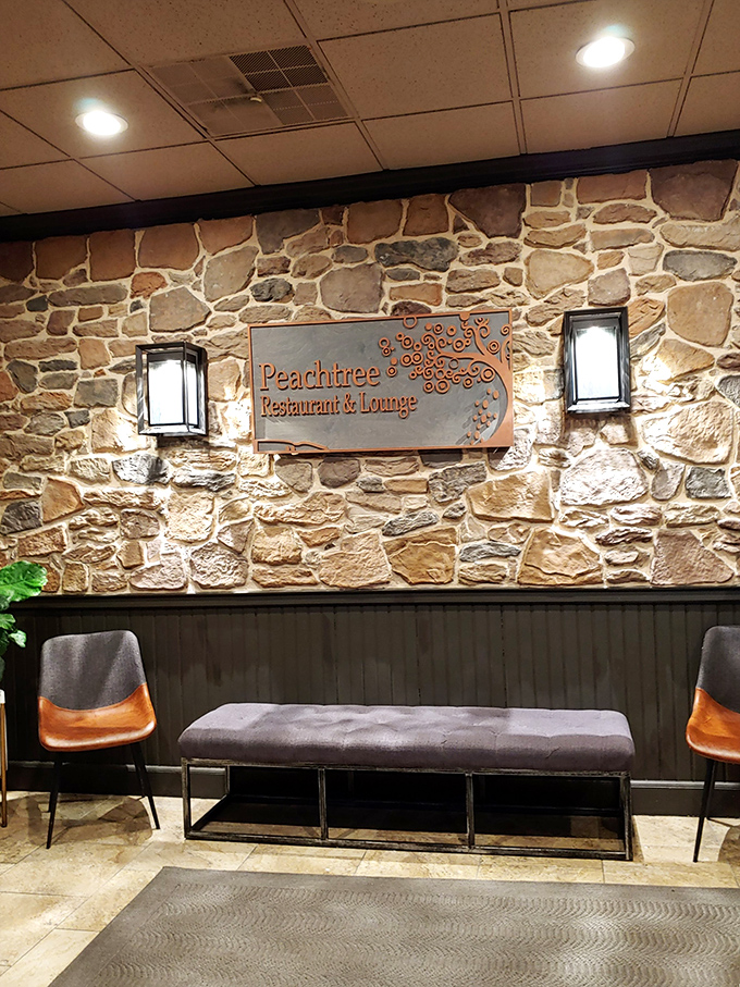 The waiting area where anticipation builds. That elegant Peachtree sign against natural stone suggests you've made a very good decision with your dining plans. 