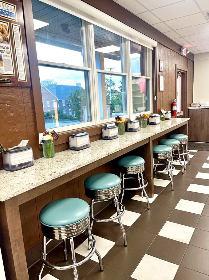 Counter seating with a view&mdash;where regulars perch on mint-green stools to watch the donut world go by, coffee in hand.