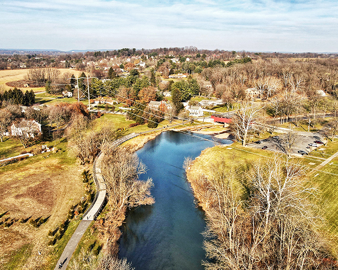 From above, the meandering blue ribbon of Jordan Creek reveals the strategic placement of the bridge, nestled perfectly into Pennsylvania's rolling landscape.