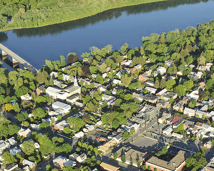 An aerial view reveals Lewisburg nestled alongside the Susquehanna River, proving paradise doesn't require oceanfront property or coastal price tags.