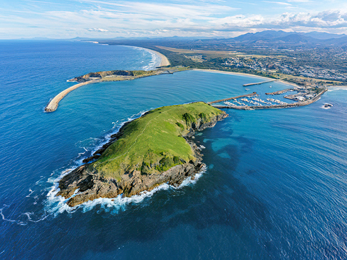The bigger picture reveals California's dramatic meeting of land and sea. This aerial view showcases the rugged beauty that makes the Pacific Coast Highway legendary.