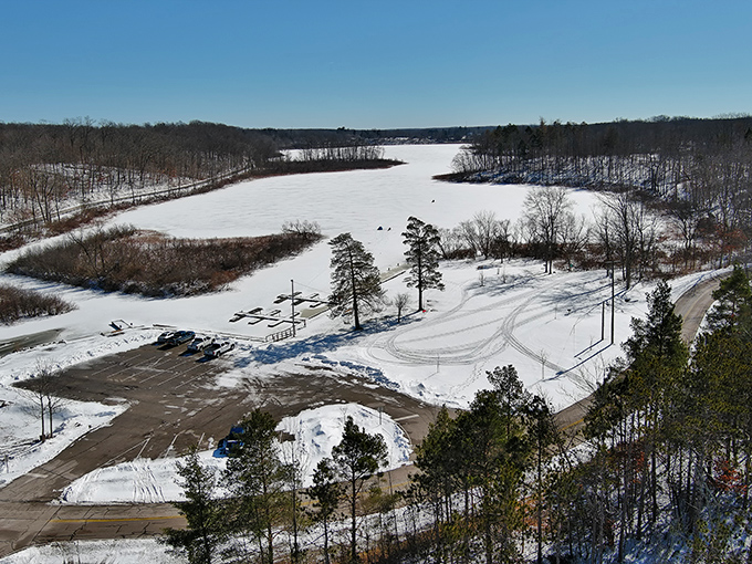Winter's white blanket transforms Punderson Lake into a frozen playground where summer's swimming spot becomes a natural ice rink.