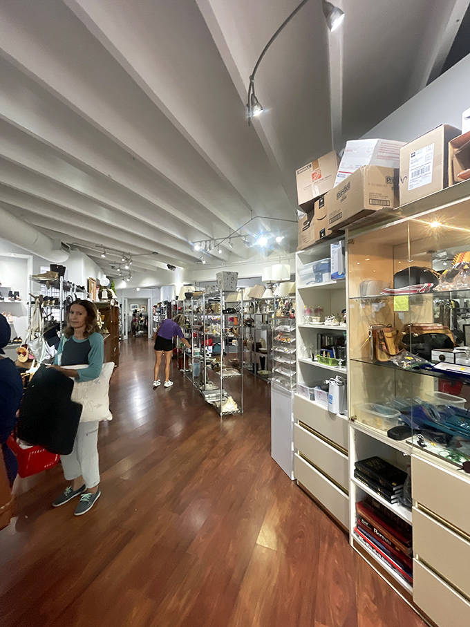 Serious thrifters in their natural habitat—notice the focused expressions and strategic shopping baskets, hallmarks of experienced treasure hunters.