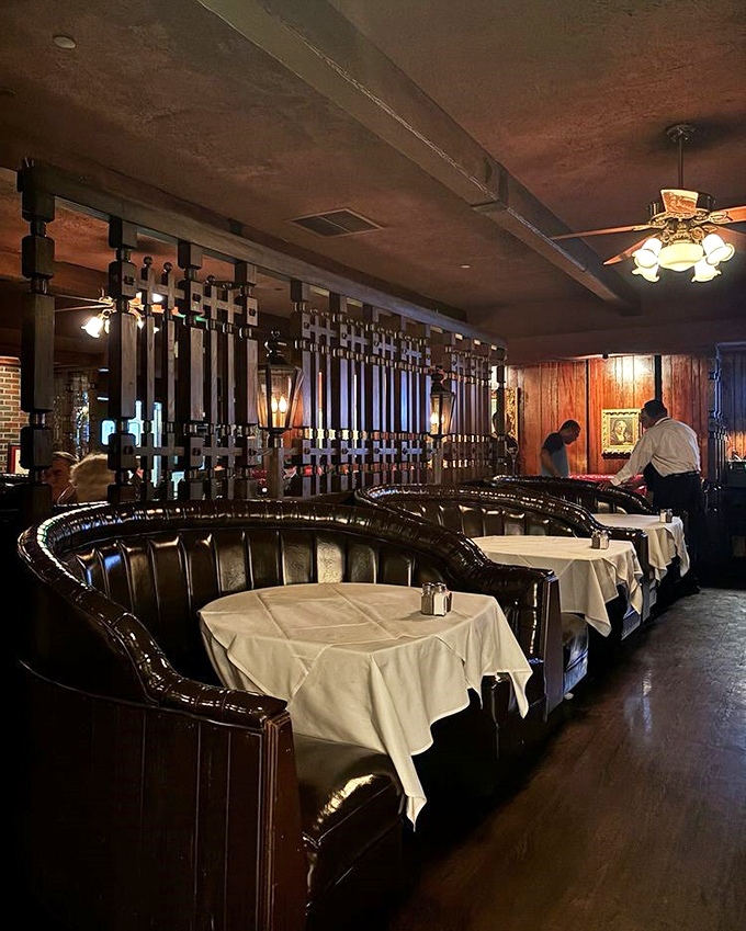 These curved booths aren't just seating&mdash;they're conversation cocoons where deals are made, anniversaries celebrated, and diet plans temporarily suspended.