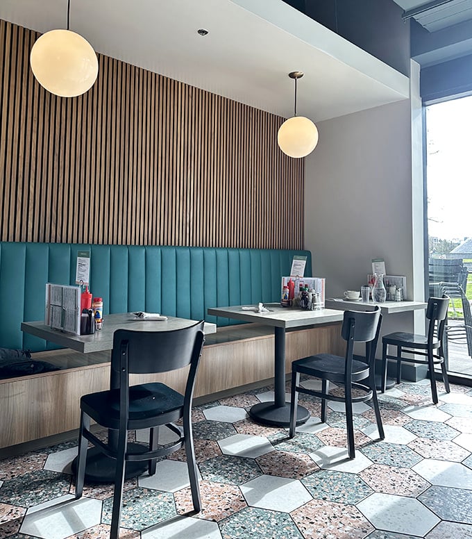Wooden slats and turquoise booths create cozy breakfast nooks where Seattle's morning philosophers contemplate the perfect bite of eggs and hollandaise.