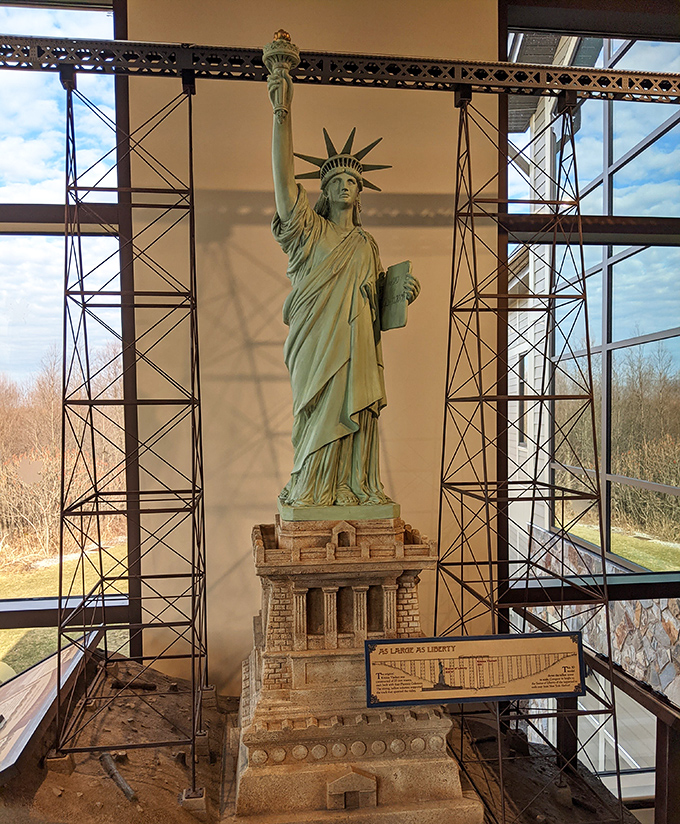 Engineering meets art. The visitor center's scale model of the Statue of Liberty stands between bridge towers, illustrating the impressive height of the original structure.