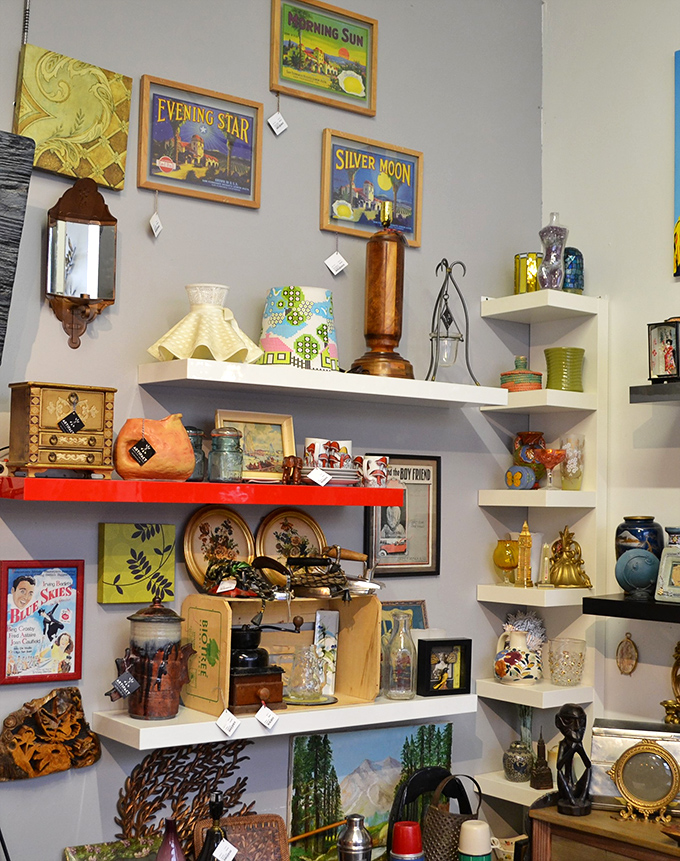Vintage treasures arranged with curatorial precision. Each shelf tells a different story, from mid-century modern to kitschy Americana charm.