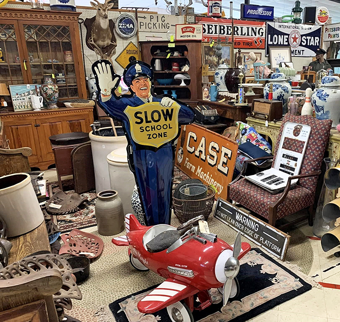 That crossing guard figure has been keeping vintage toys safe for decades. The red pedal plane nearby is ready for its next imaginary takeoff.