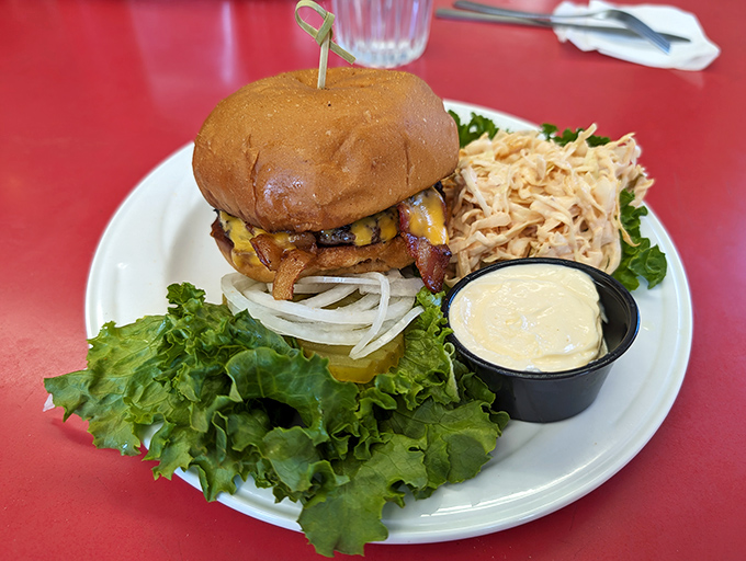 A burger that understands the importance of proper architecture: sturdy bun foundation, fresh lettuce, perfectly melted cheese, and a beef patty cooked with respect.